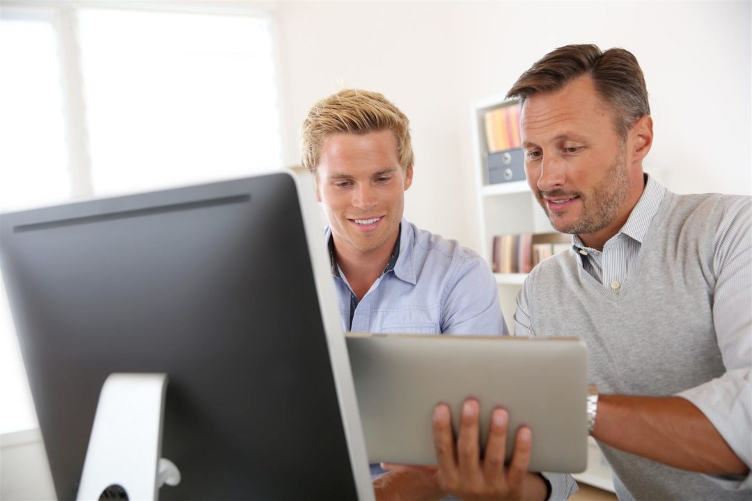 Manager with employee working in office - Next Step Apprenticeships